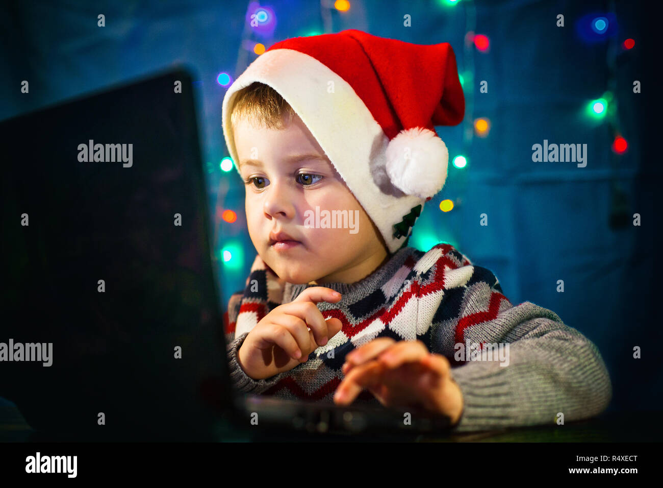 Little child writing letter to Santa Claus on laptop computer. Little ...