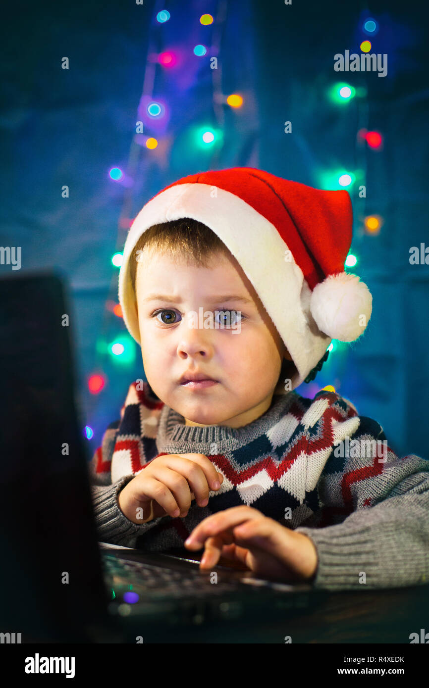 Little child writing letter to Santa Claus on laptop computer. Little ...