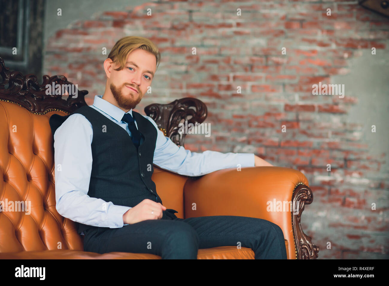 Portrait of blonde young man with uncommon appearance wears white t ...