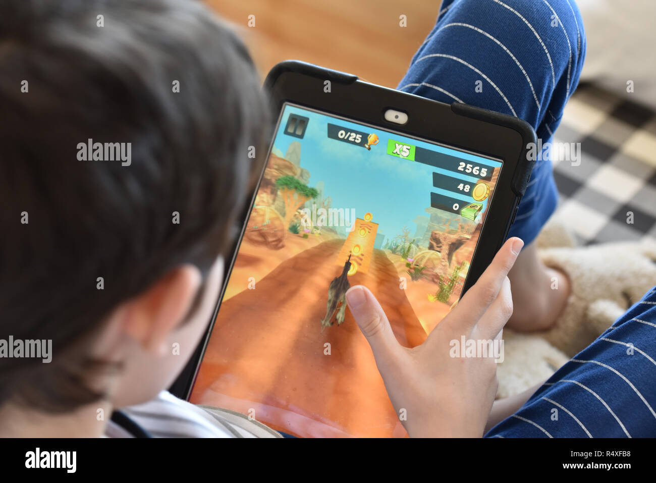 Child playing games on a tablet Stock Photo - Alamy