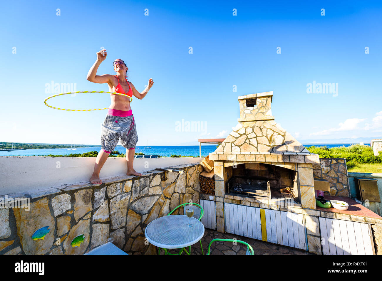 Attractive adult woman is playing with hula hoop in nature. Young ...