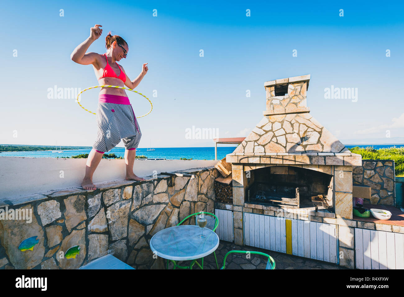 Attractive adult woman is playing with hula hoop in nature. Young ...