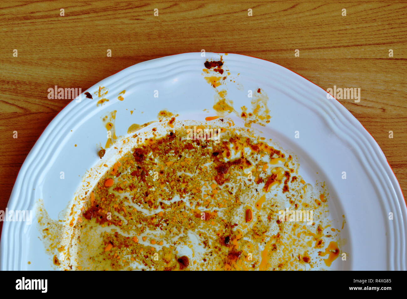 food stain left after eat on white dish Stock Photo - Alamy