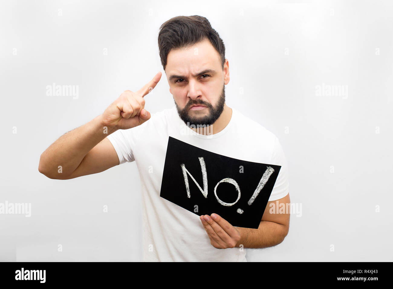 Serious and angry man stand and hold plate with written word no. He ...