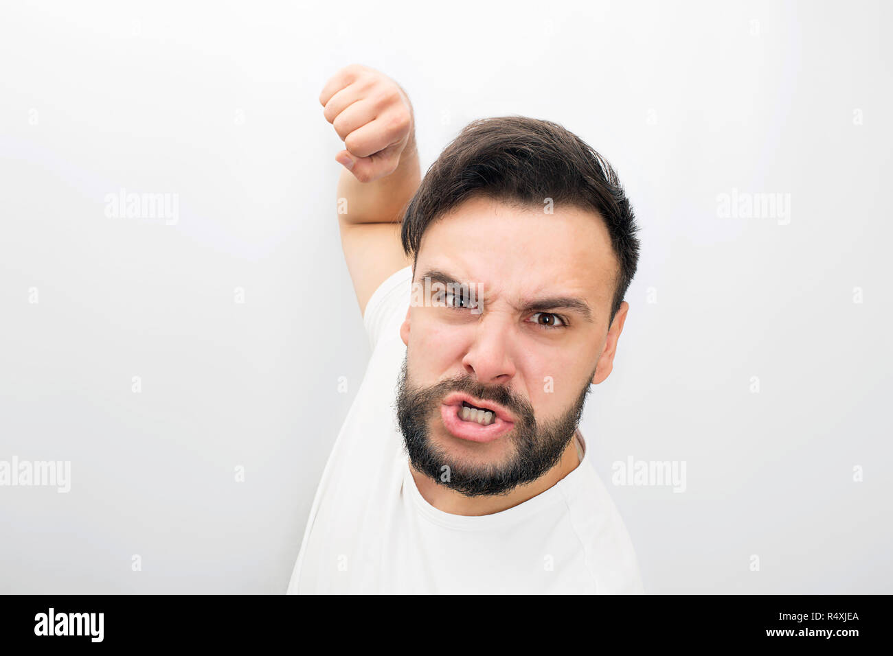 Very angry man looks on camera. He is ready to fight with fist. He ...