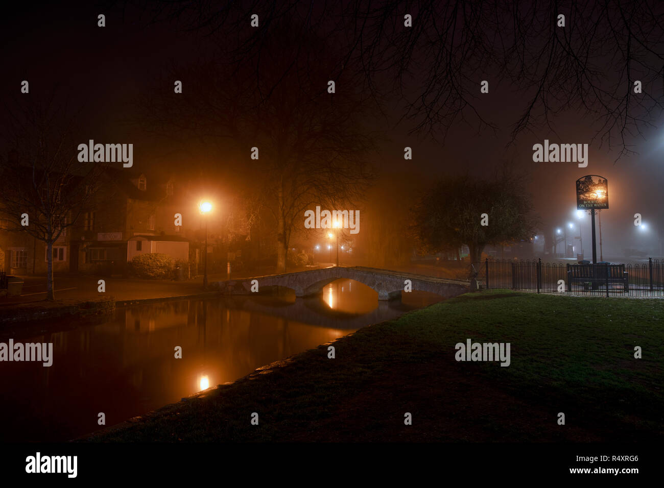 Mist and fog before dawn in the cotswold village of Bourton on the ...