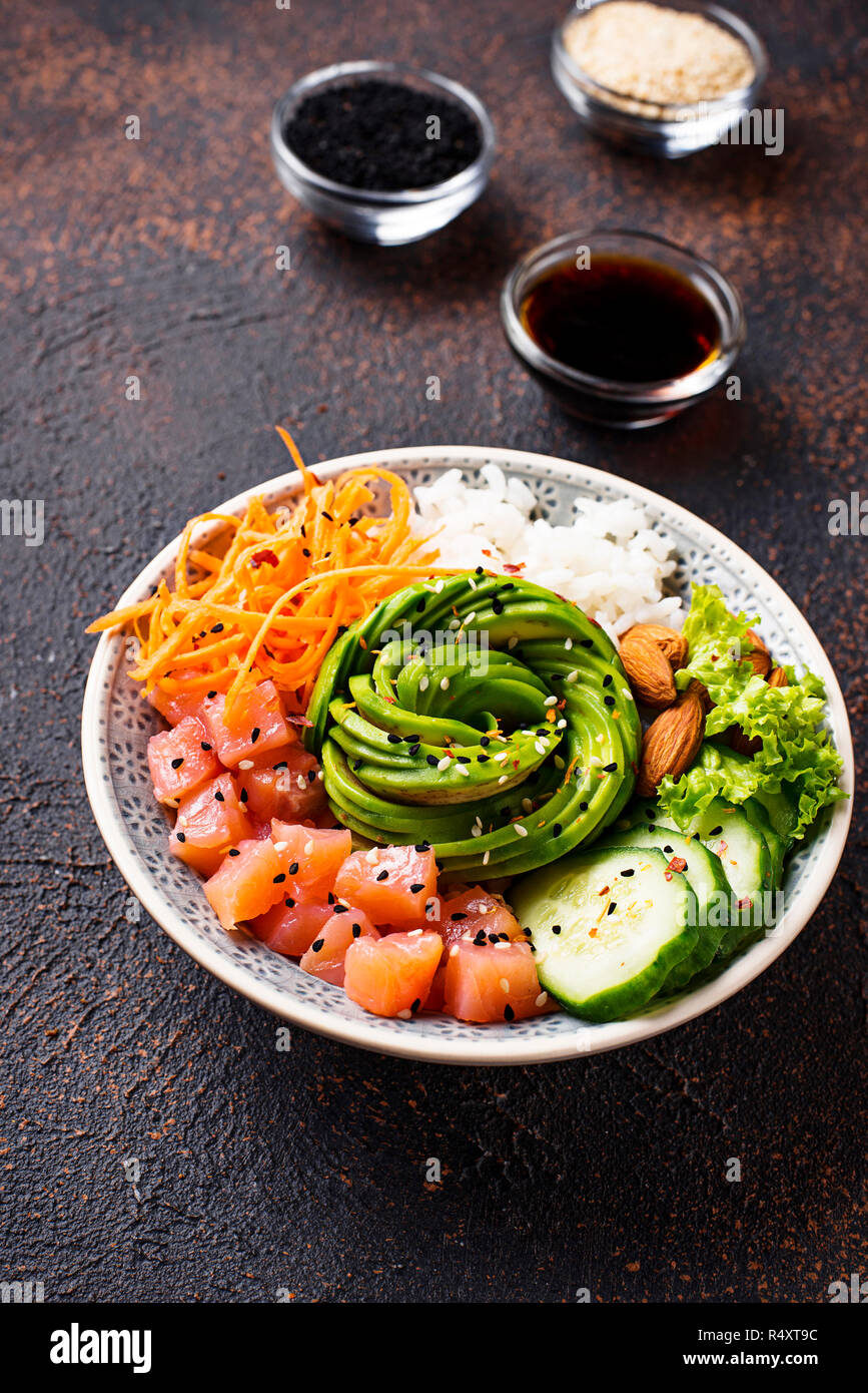 Hawaiian poke bowl with salmon, rice, avocado, carrot and cucumber ...