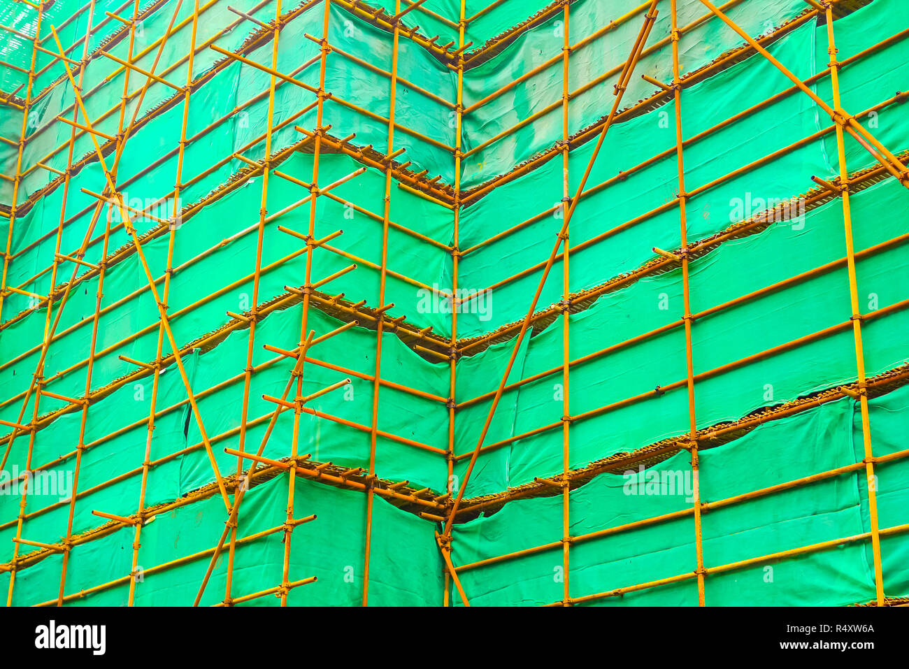 Steel scaffolding with a green curtain in a construction site in ...