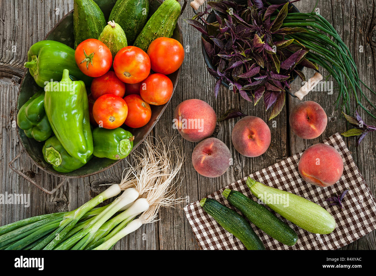 Overhead view of fresh fruits and vegetables in baskets on a wooden ...