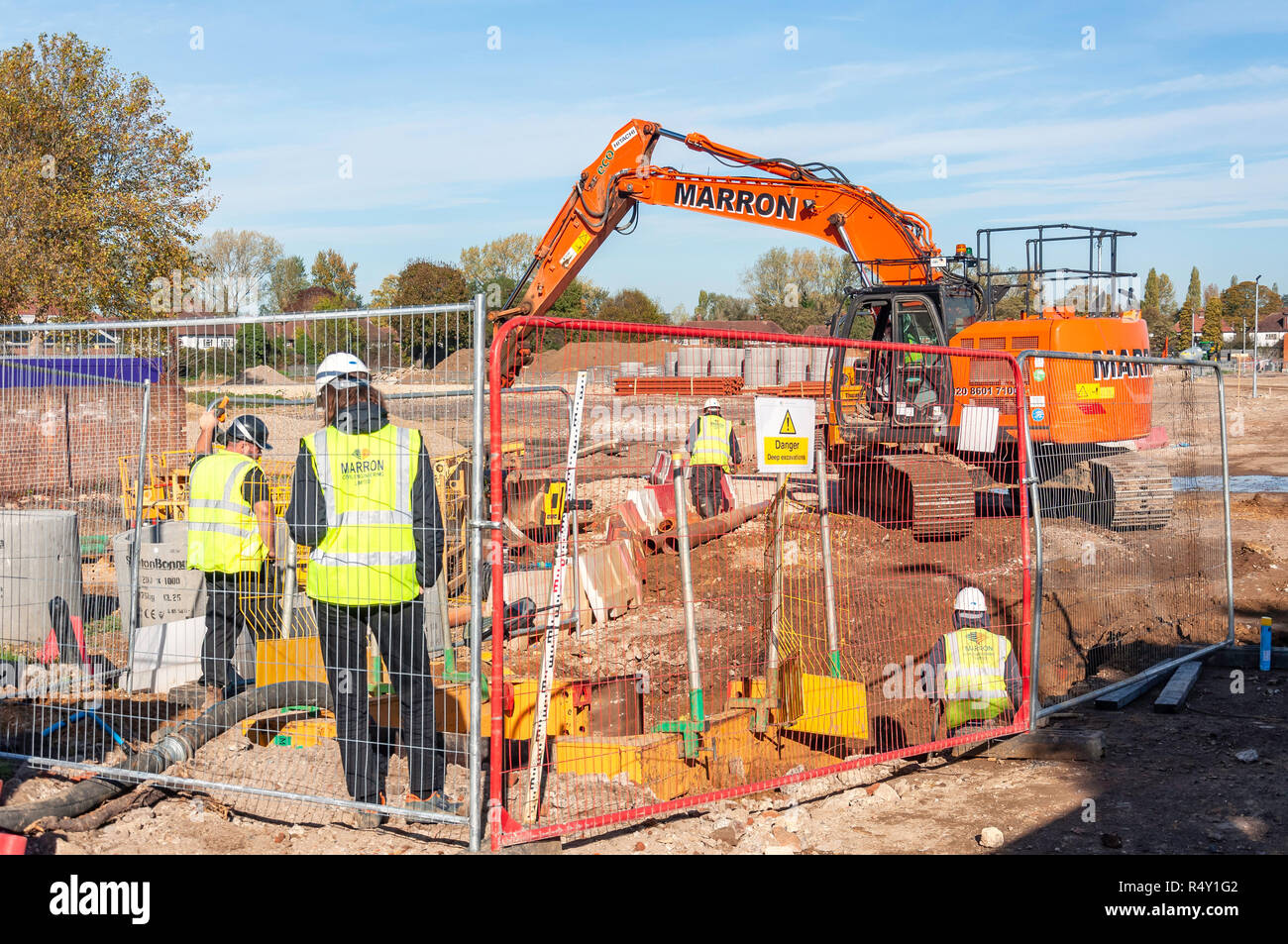 Hitachi hybrid hydraulic excavator at work on construction site ...
