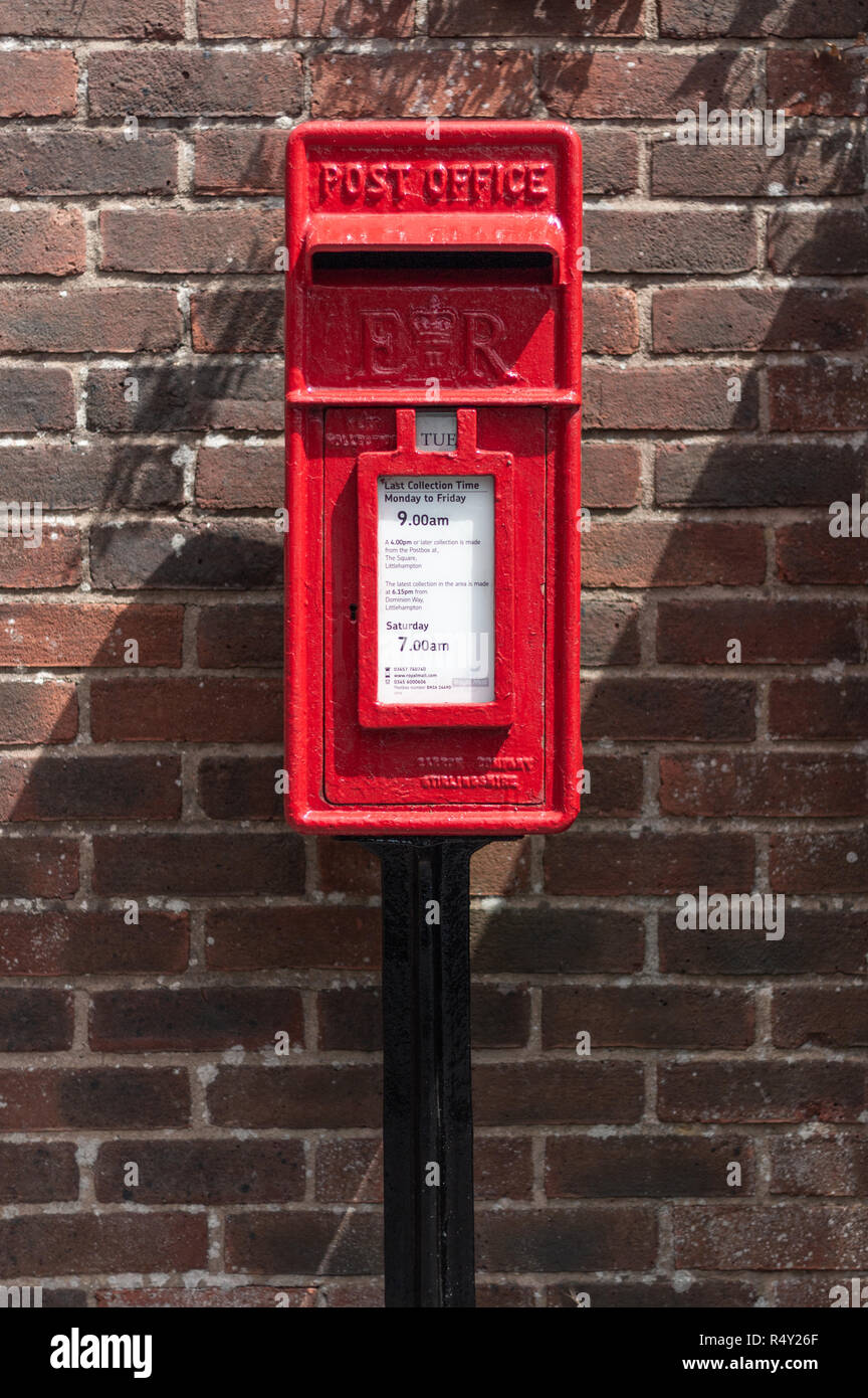 UK red post box next to a brick wall Stock Photo - Alamy