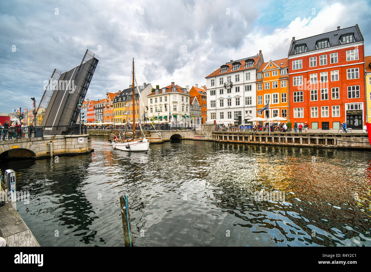 The Nyhavn bridge opens to let a small sailboat through the canal in ...