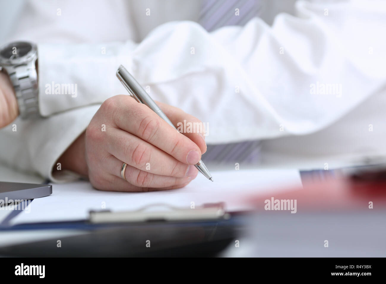 Male arm in suit and tie hold silver pen Stock Photo - Alamy