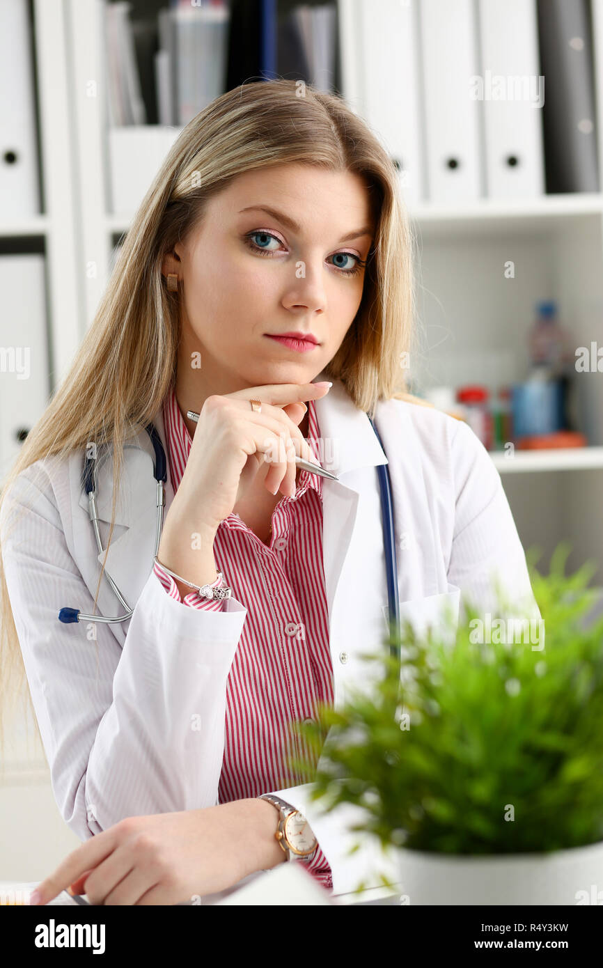 Beautiful smiling female doctor sit at workplace Stock Photo - Alamy