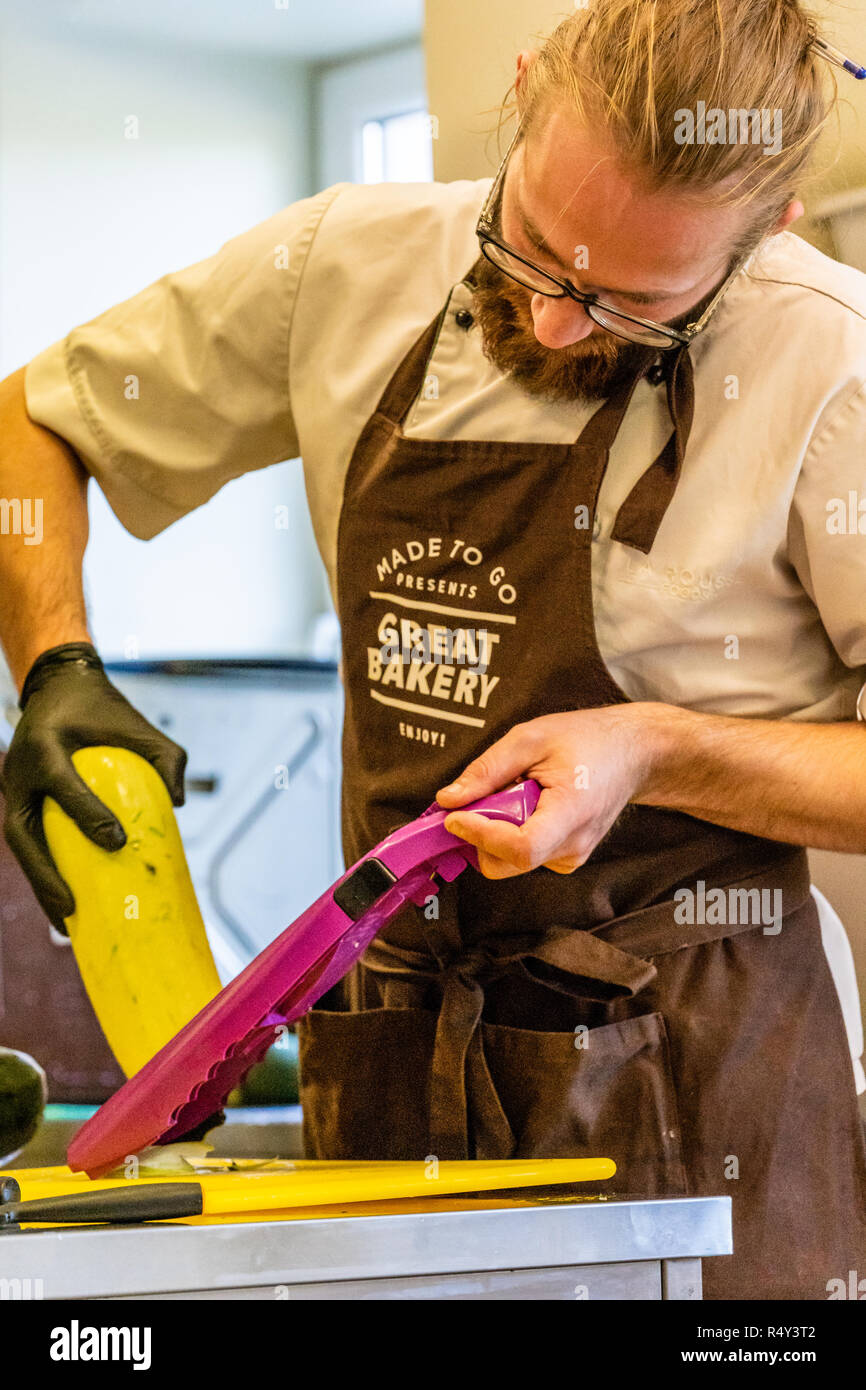 Male Chef Cutting Eggplant in the Kitchen - with Glove on his Hand ...