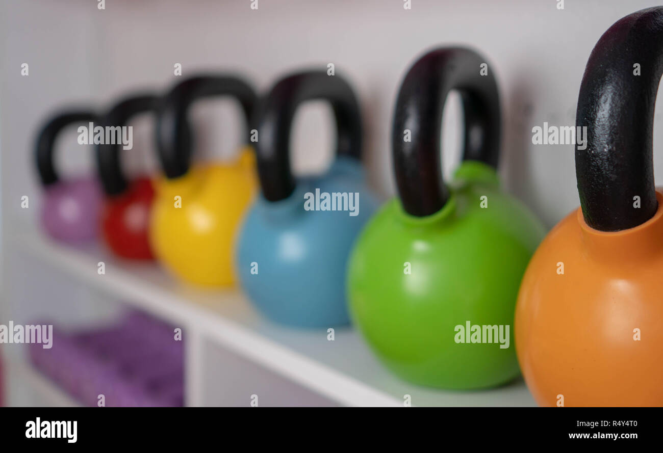 multi-colored weights in the female fitness center. kettlebells are on ...