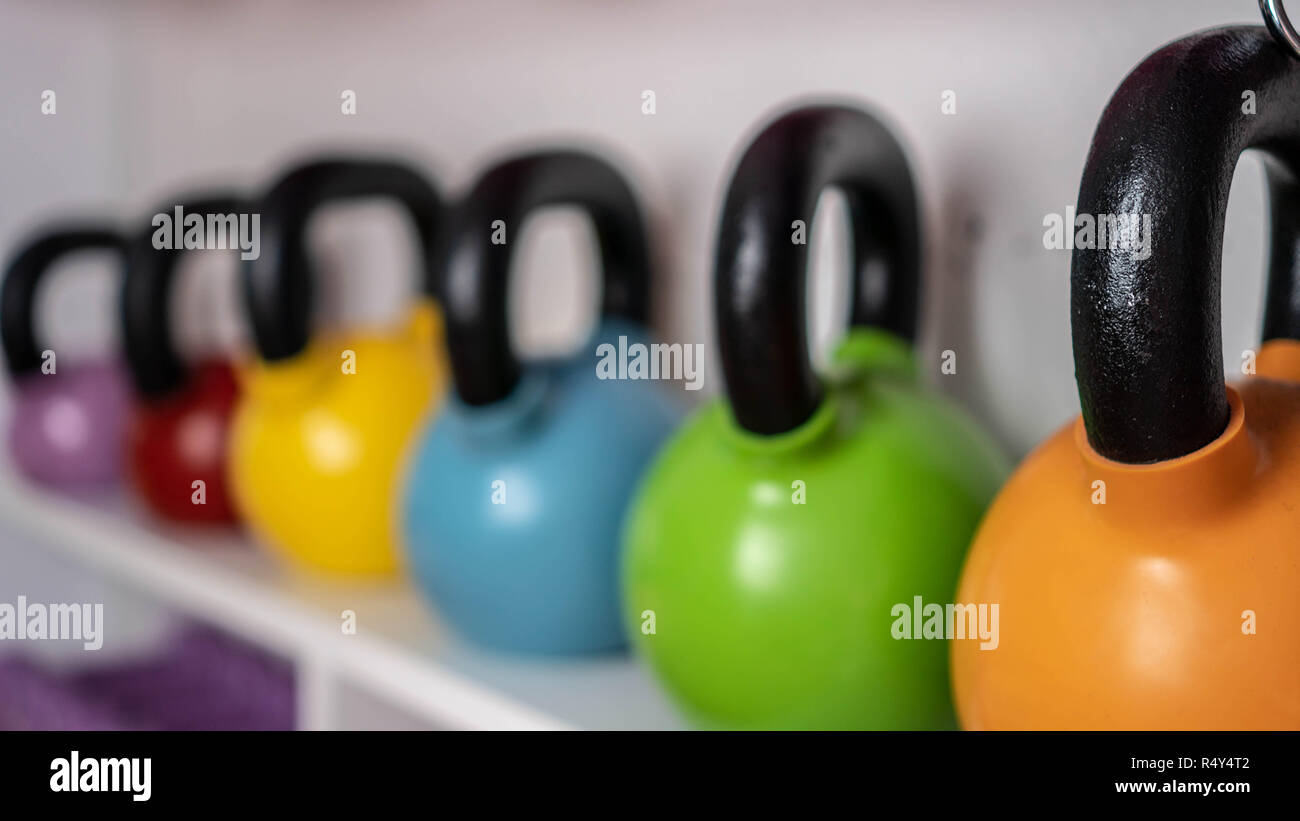 multi-colored weights in the female fitness center. kettlebells are on ...