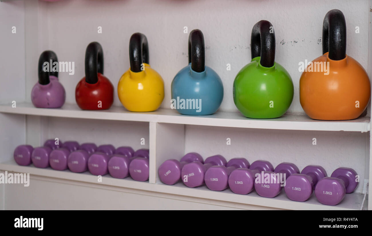 multi-colored weights in the female fitness center. kettlebells are on ...