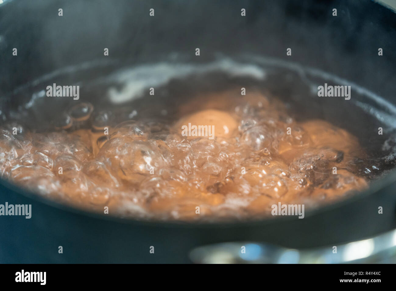 Eggs Boiling in Water - Closeup View with Smoke Partly Covering the ...