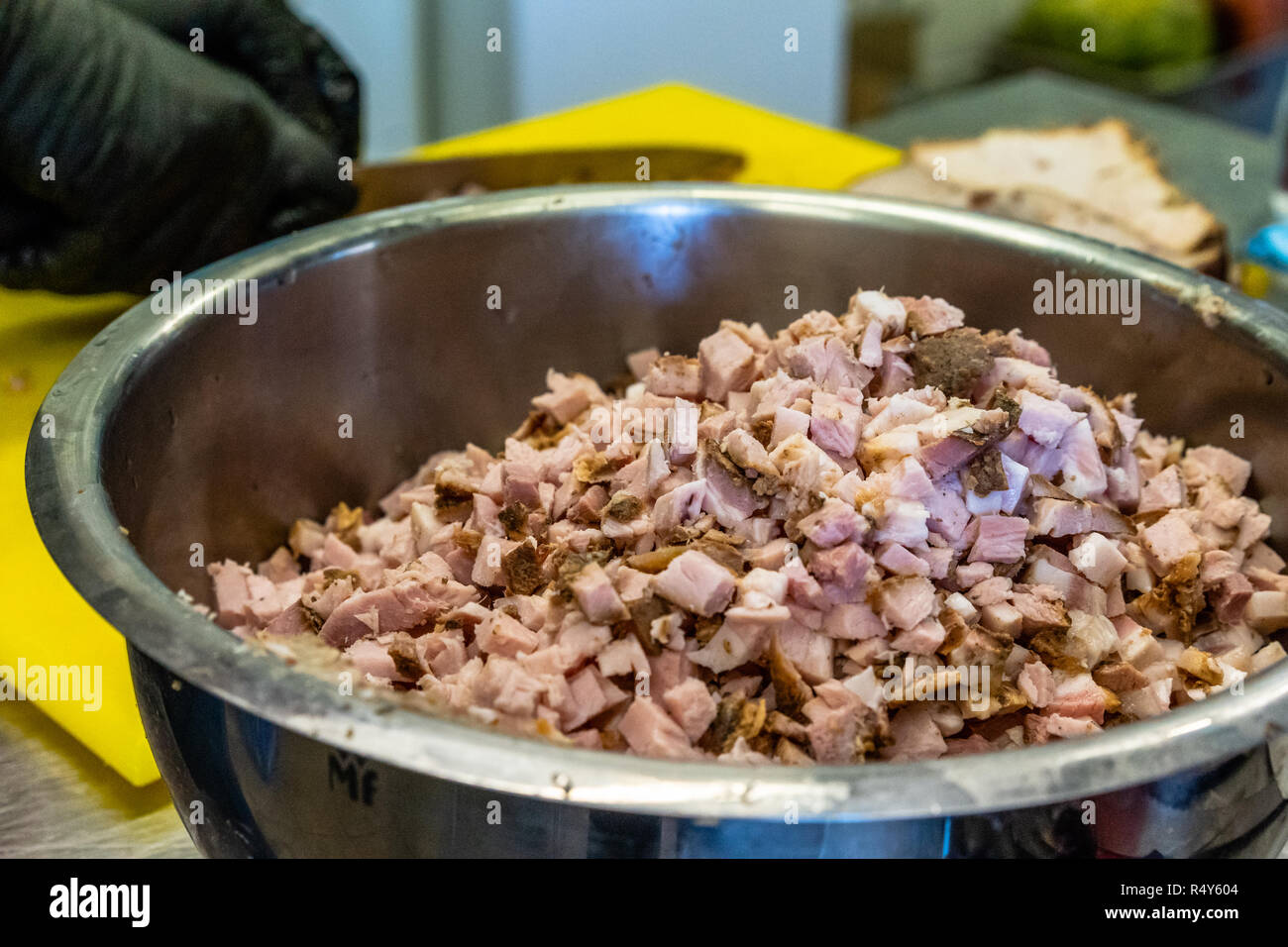 Stainless Steel Bowl with Chopped Ham - Chef Chopping Ham in Background ...