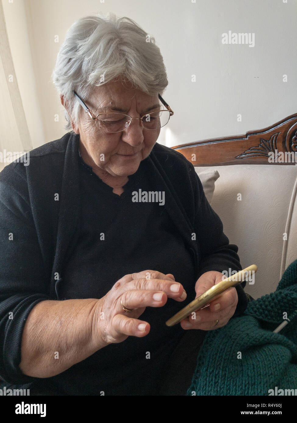 Old woman uses mobile technology Stock Photo - Alamy
