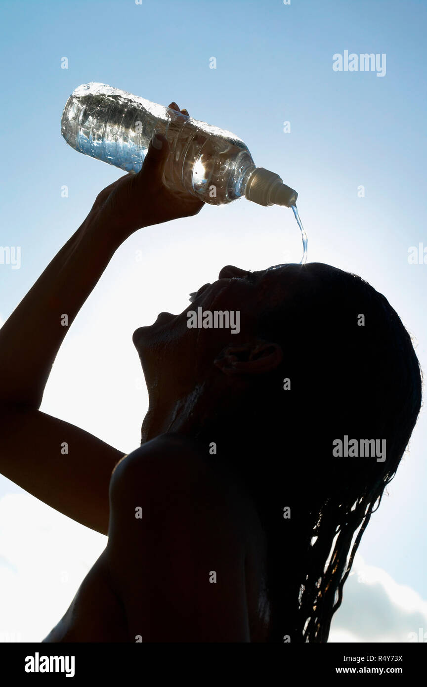 Silhouette young woman pouring water hi-res stock photography and ...