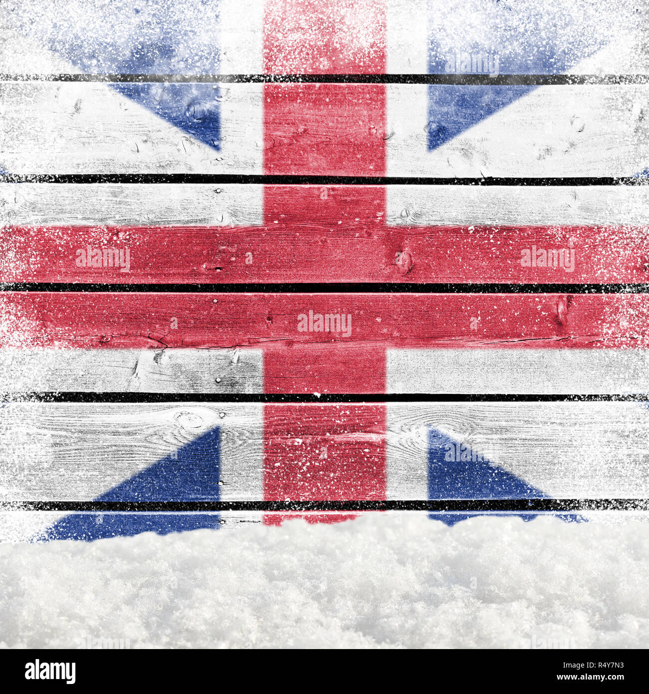 Winter background with wooden wall, falling snow, snowdrift and England ...