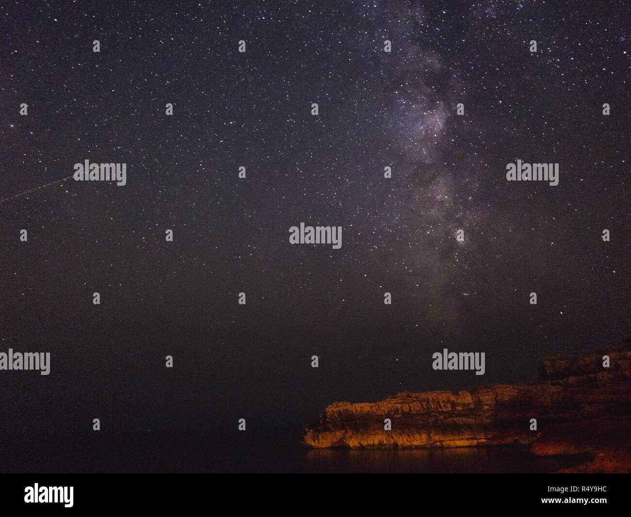 Milky way and shooting star over the cliff, long exposure image Stock ...