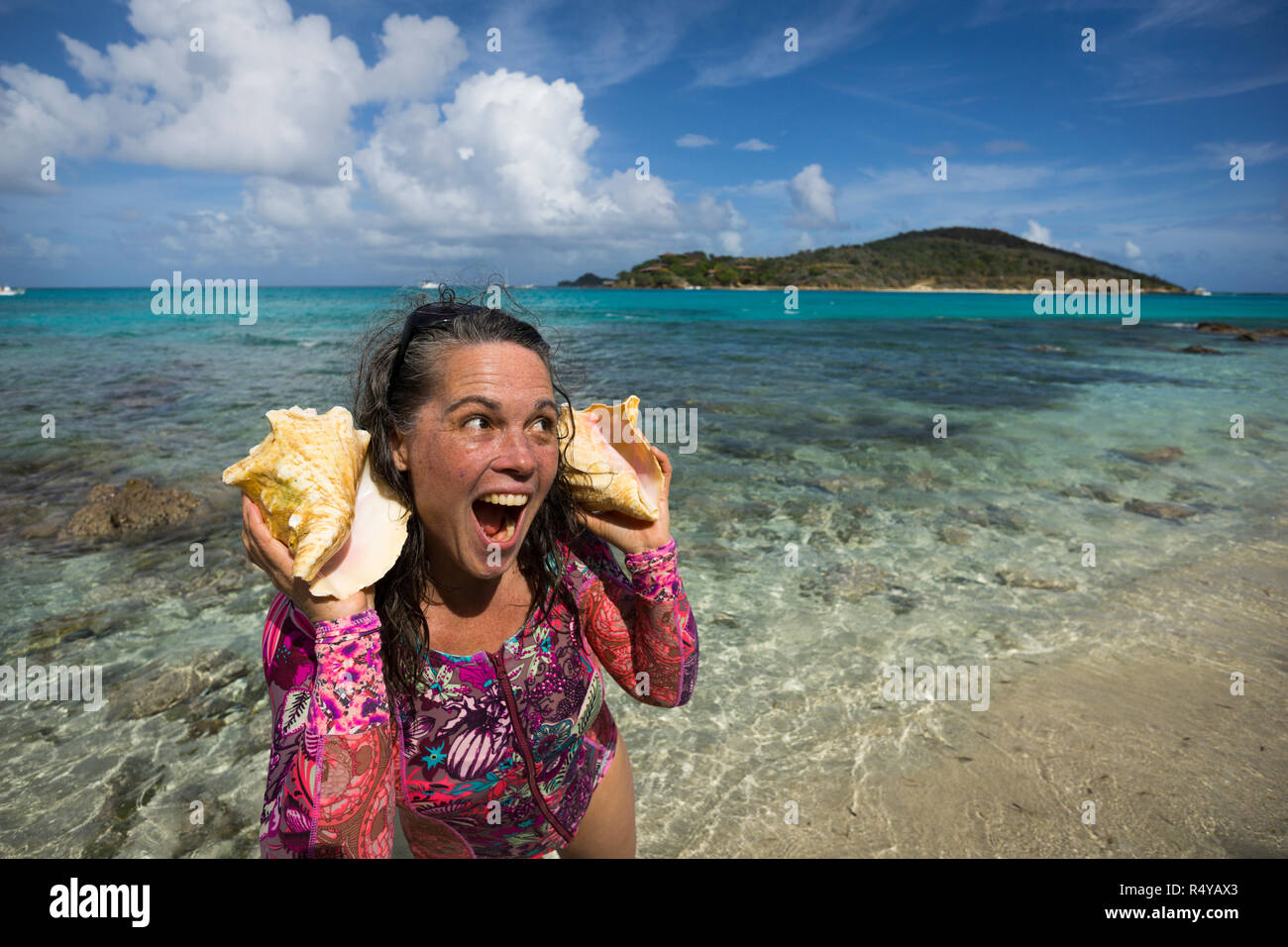 A woman plays with Conch Shells littered on Prickly Pear Island near ...