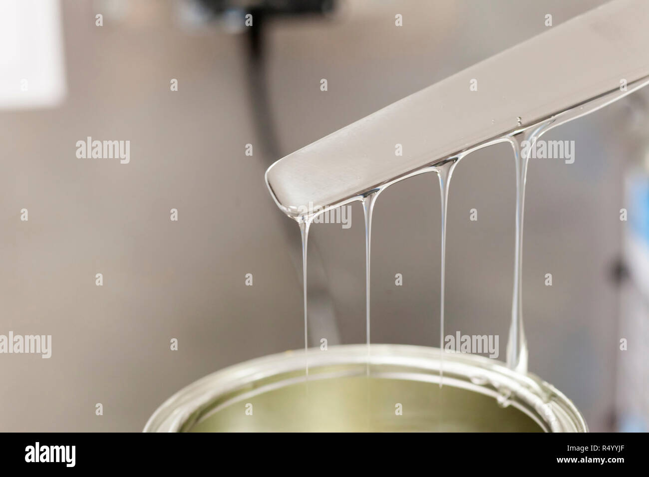 Technician weighing paint resin in a can on a balance by spatula Stock ...
