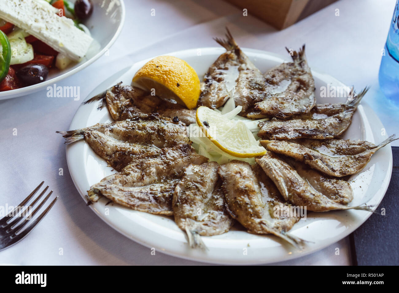 Small fried fish appetizer served with lemon Stock Photo - Alamy