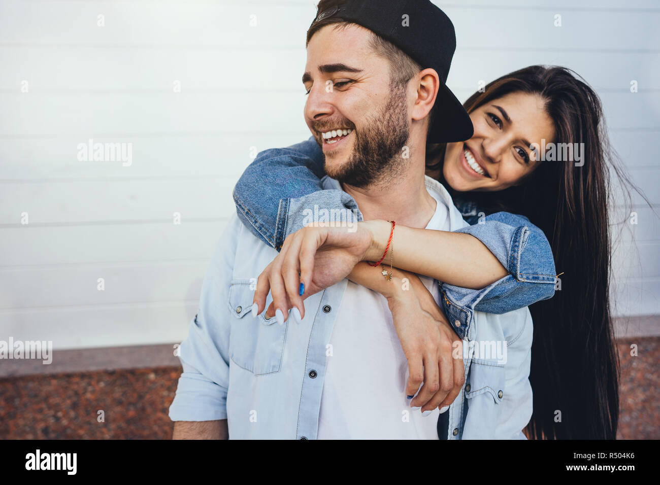 Young beautiful girl hugging her handsome boyfriend Stock Photo - Alamy