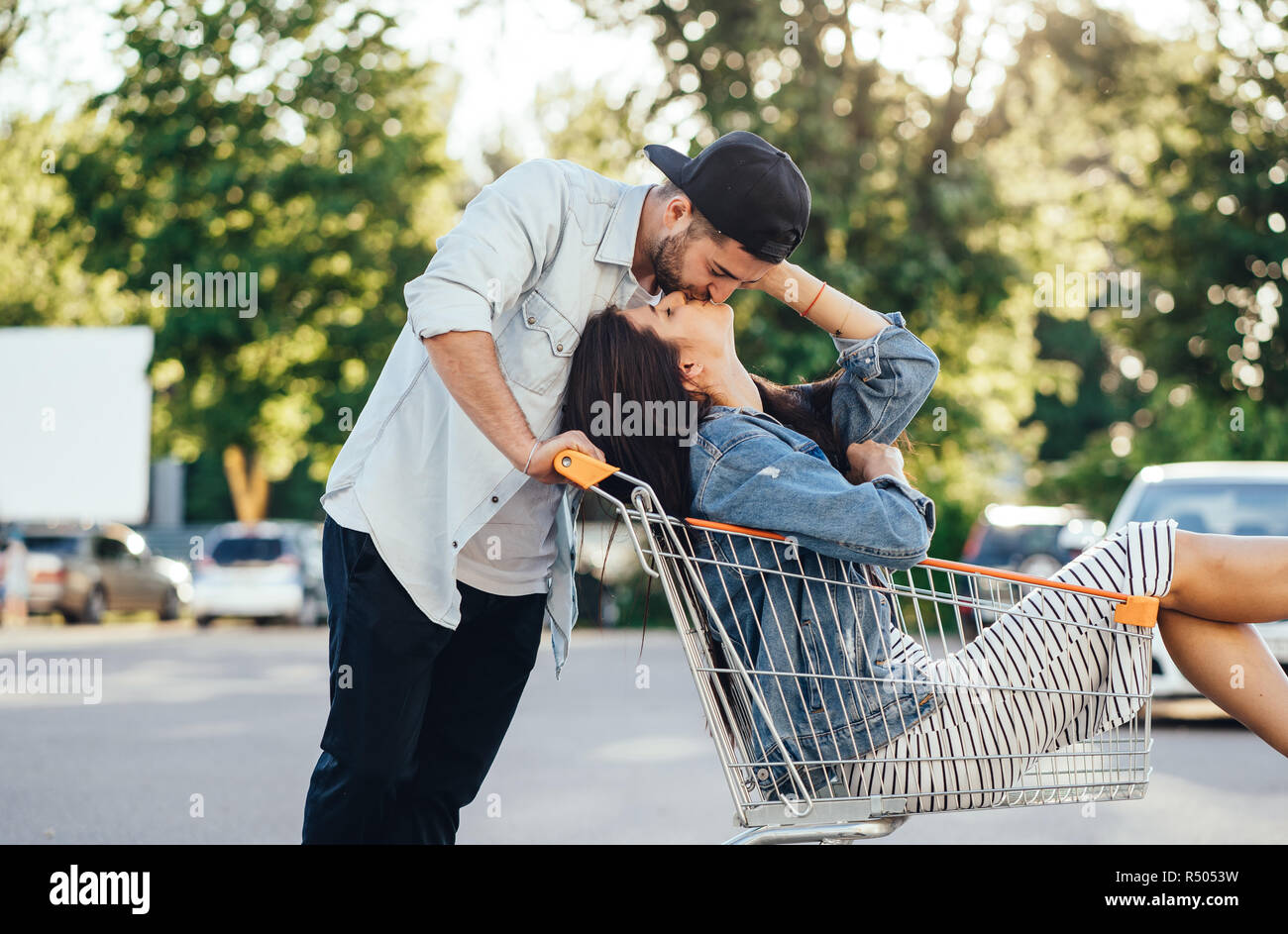 Handsome Guy Carries His Girlfriend In Cart Guy Kisses His Girlfriend