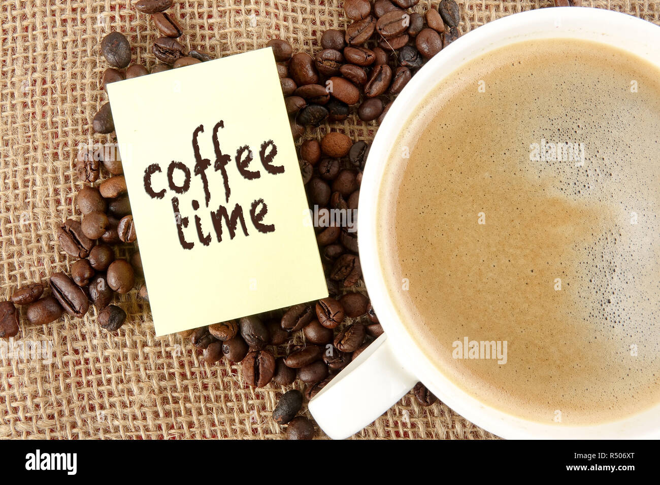 Coffee beans and a cup of coffee with COFFEE TIME words over a rug ...