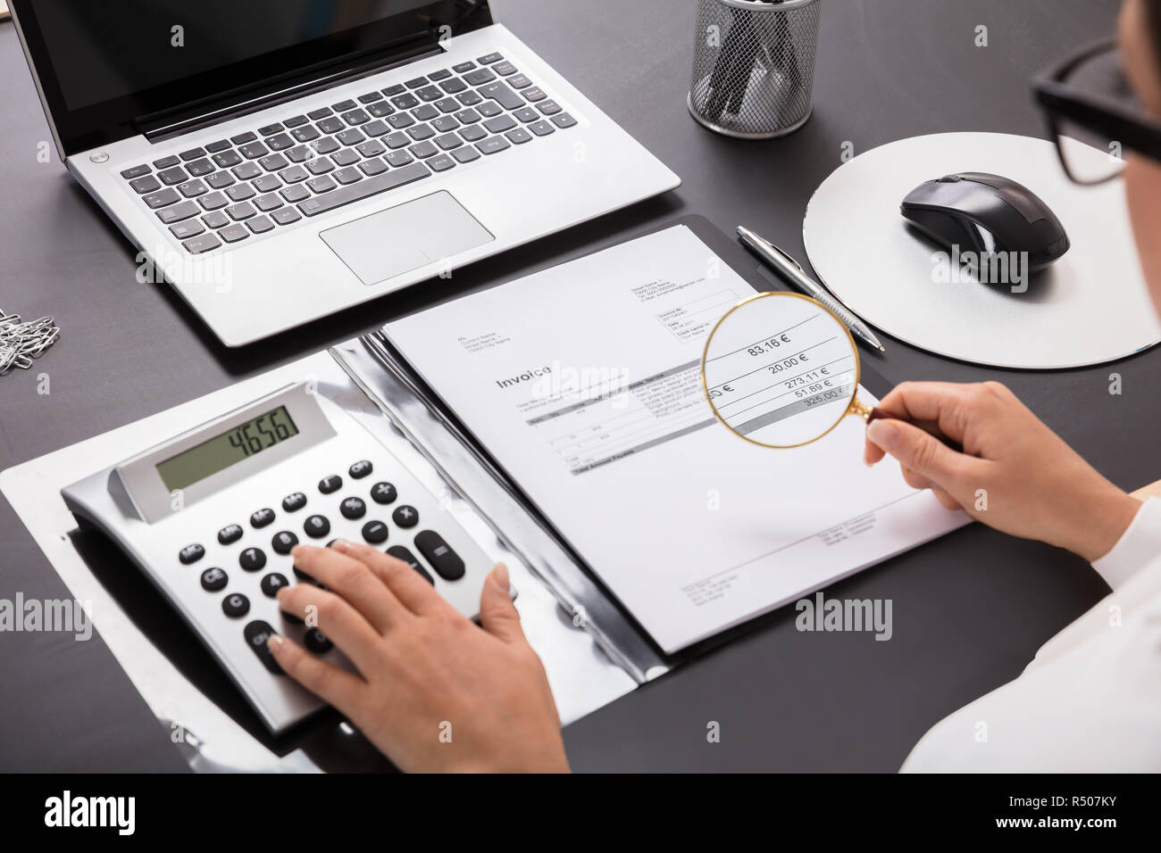 Businesswoman Looking Invoice Through Magnifying Glass Stock Photo - Alamy