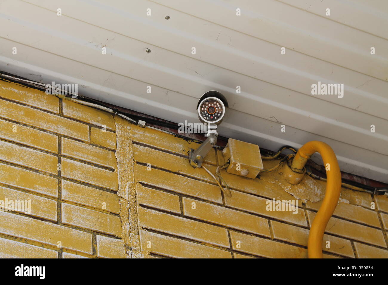 CCTV camera hanging over the entrance of a house Stock Photo - Alamy