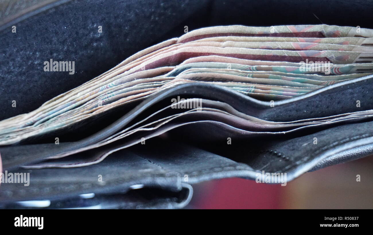 Open leather black wallet with paper money Stock Photo - Alamy