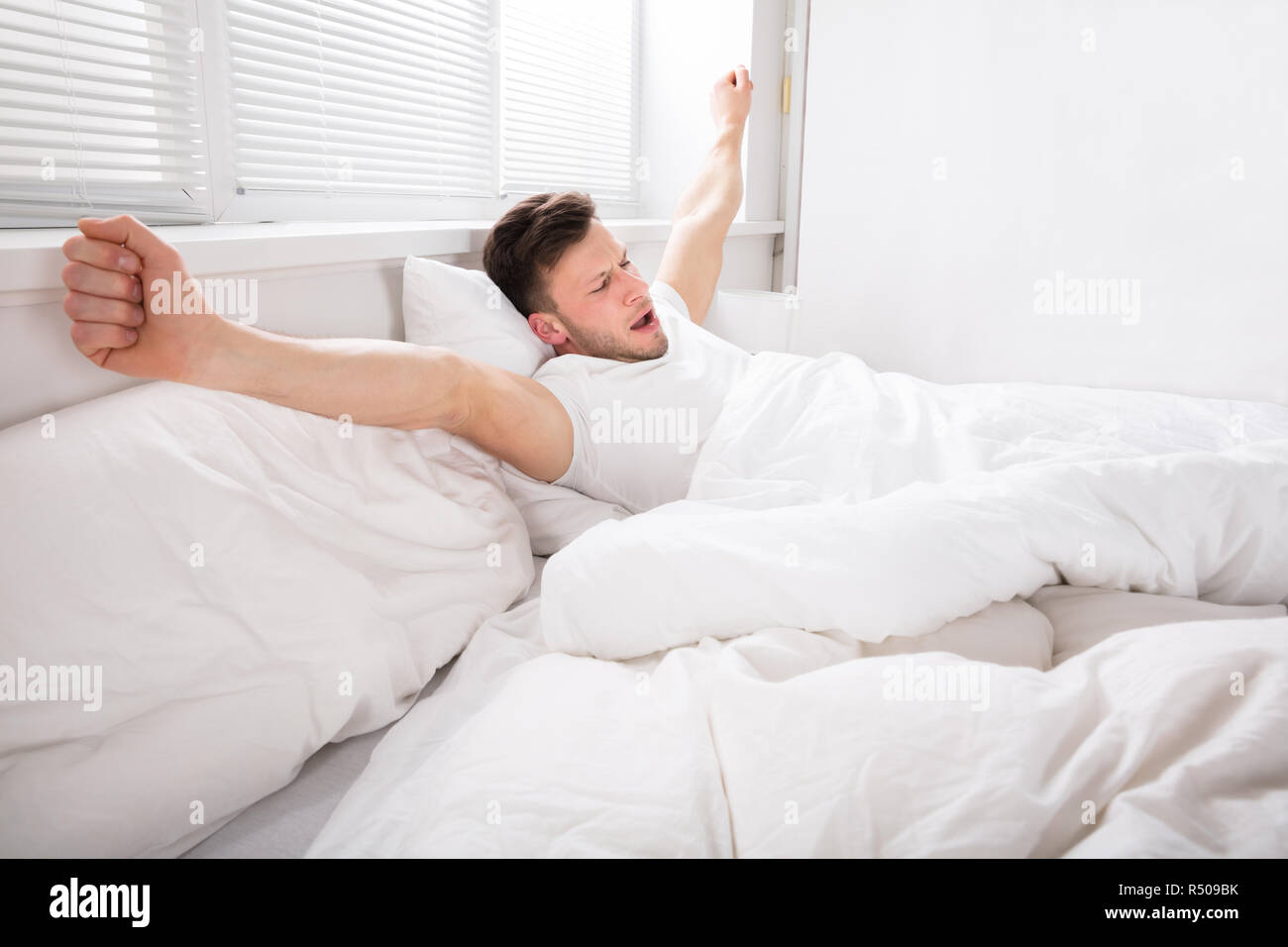 Man Stretch His Hand After Wake Up Stock Photo - Alamy