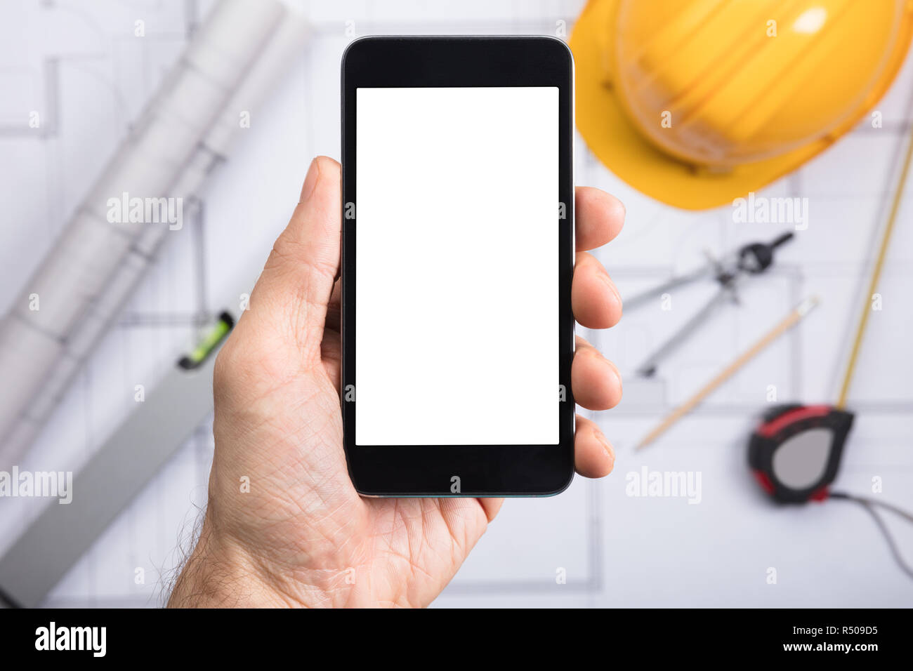 An Engineer Holding Cell Phone Stock Photo - Alamy