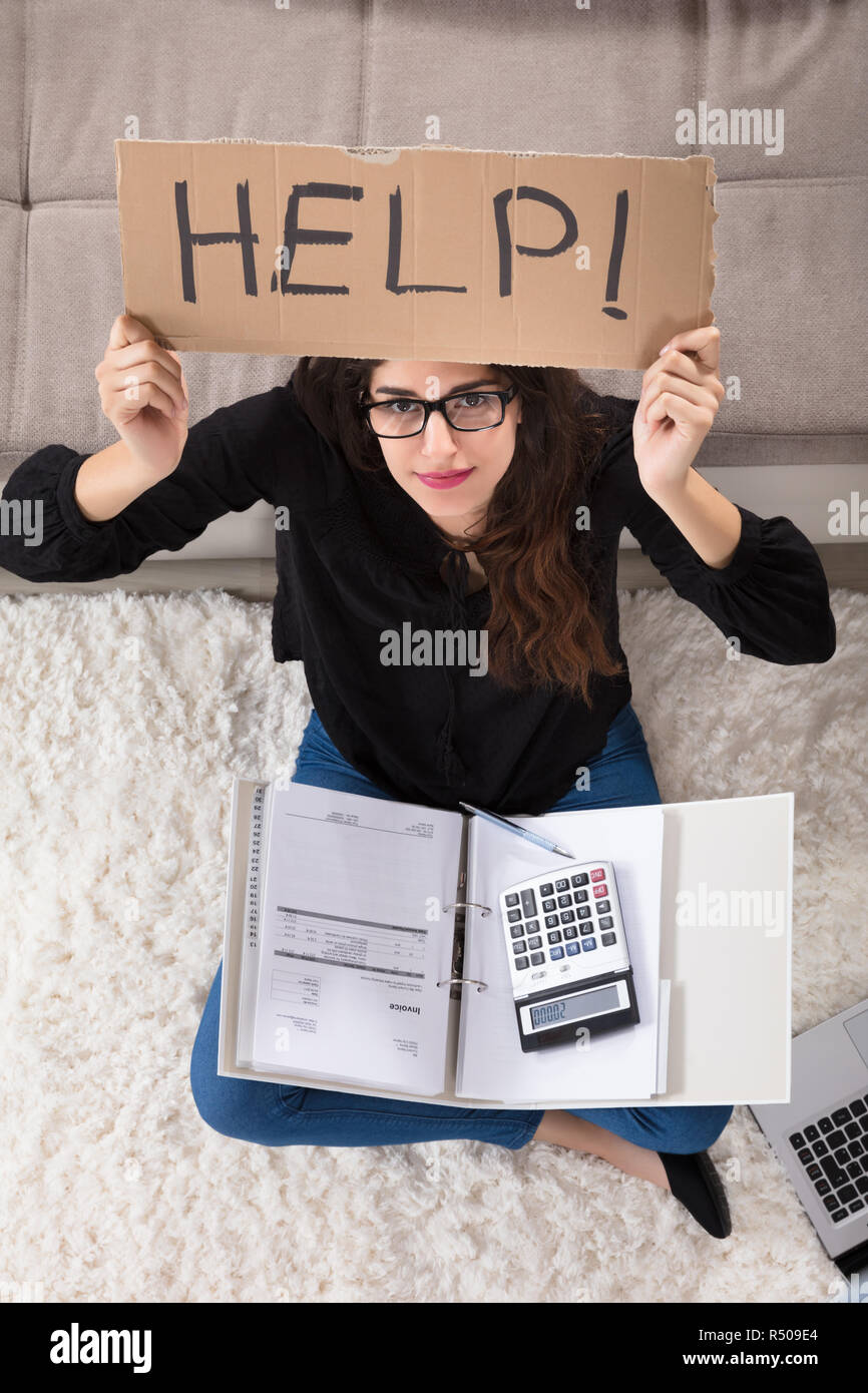 Woman With Help Sign While Calculating Bills Stock Photo - Alamy