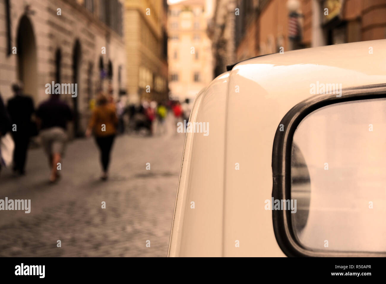 An italian vintage car parked in the streets of Rome, a nun walking on ...