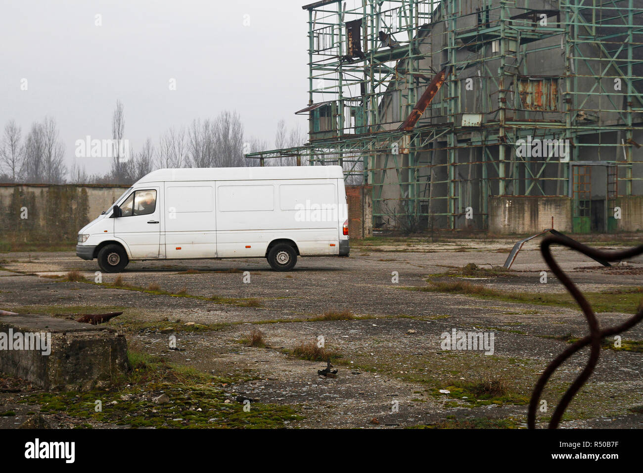 Suspicious white van moving in abandoned factory Stock Photo - Alamy