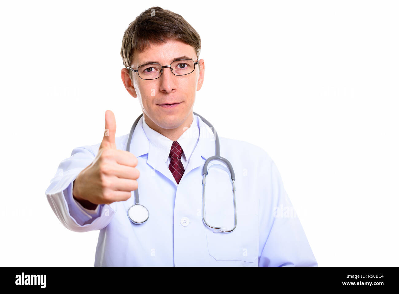 Studio shot of man doctor giving thumb up Stock Photo - Alamy