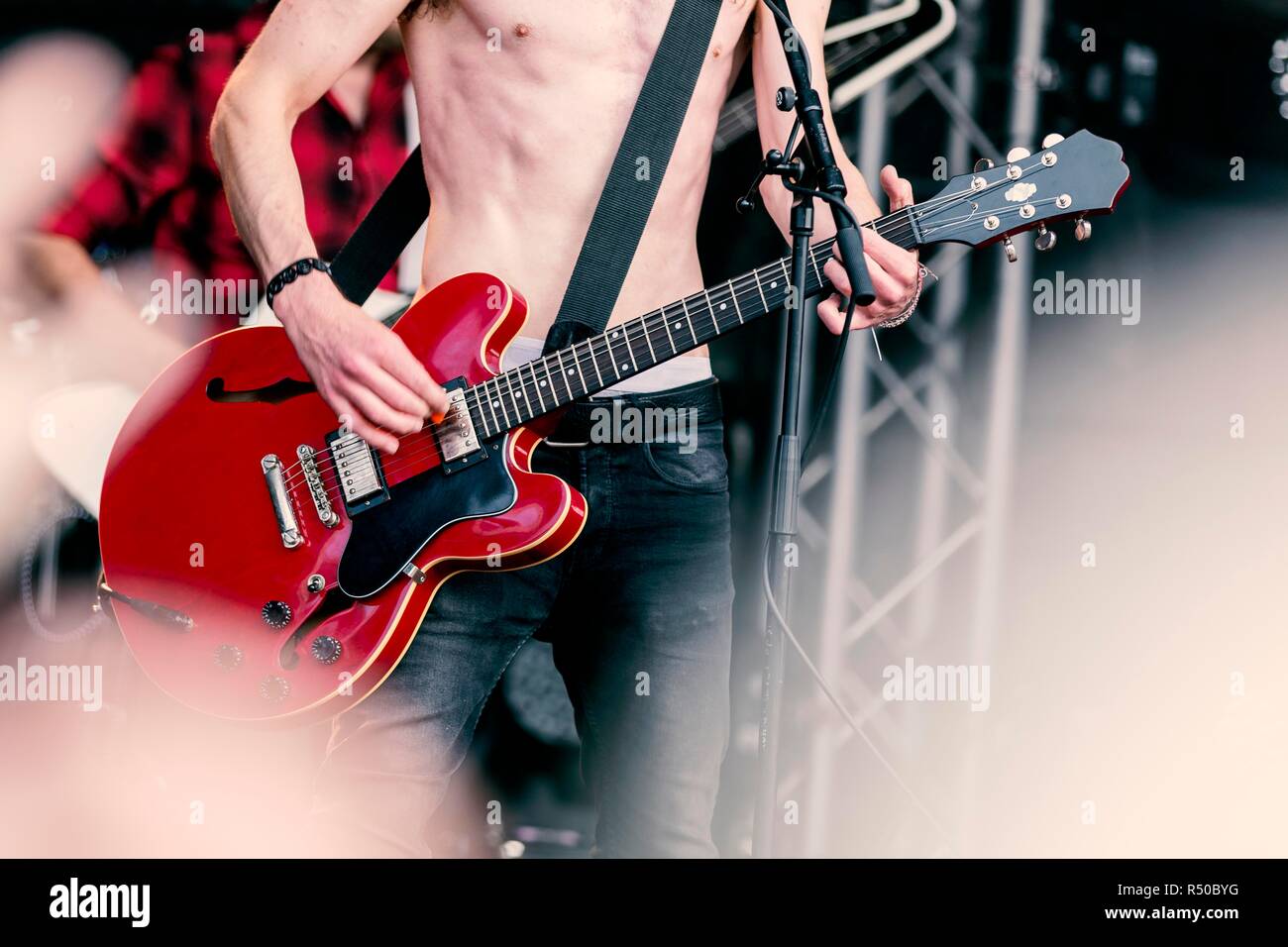 Rock band fronted by heavy metal singer with his top off showing his ...