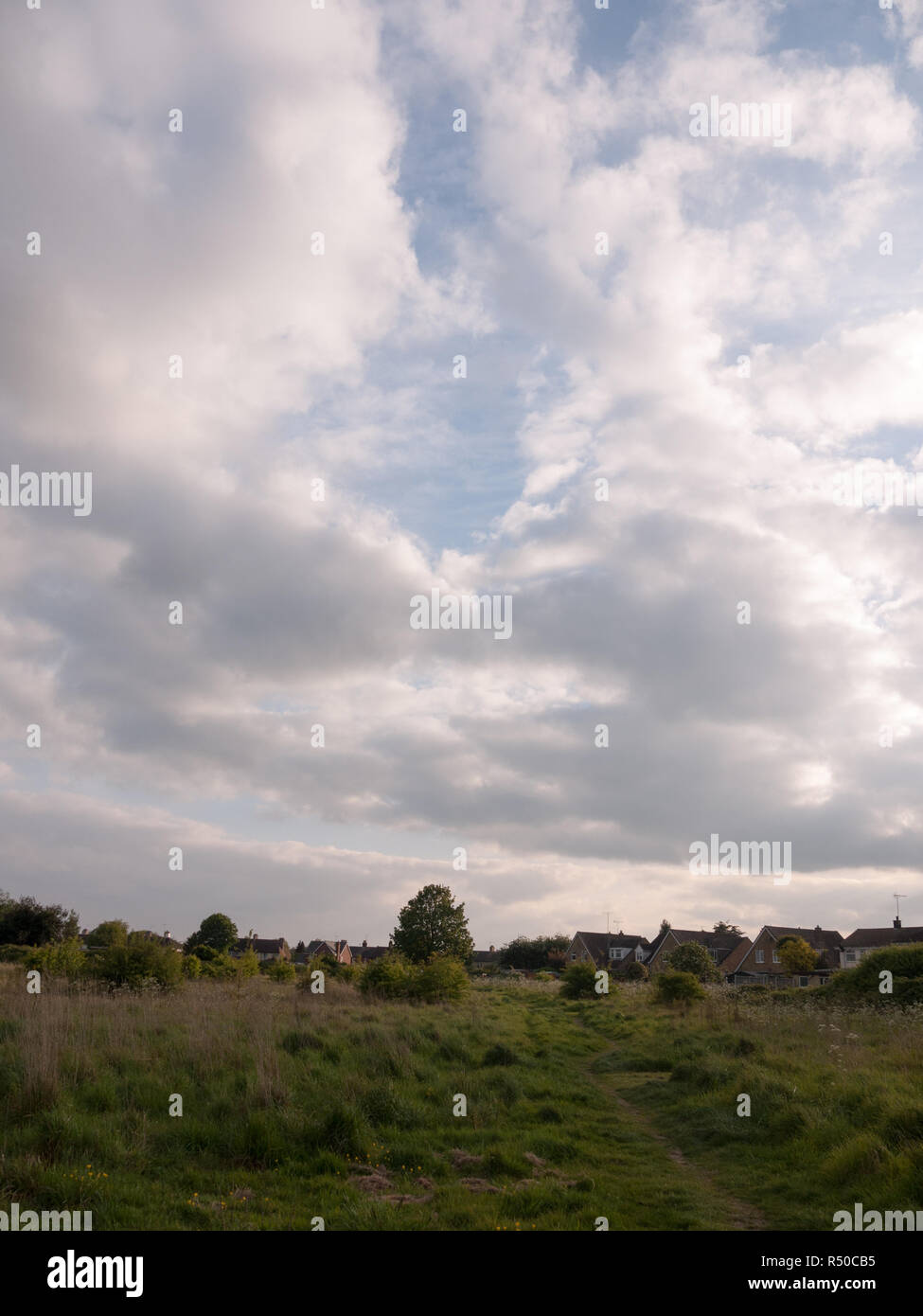 scene of countryside outside with clouds and path through the country ...