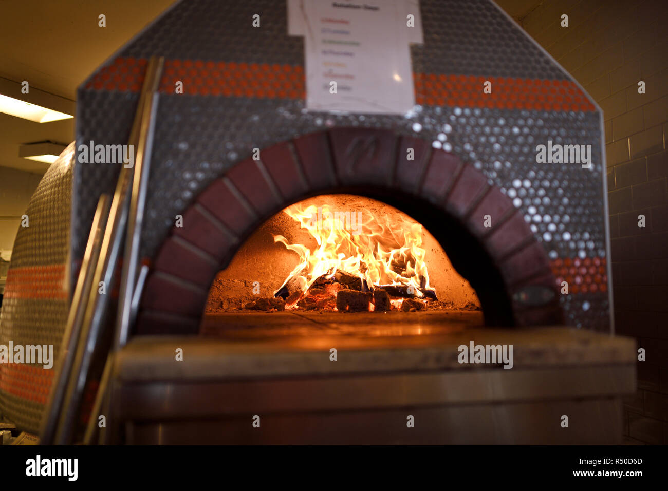 Fire in dome ceramic wood burning pizza oven at Amsterdam Brewhouse ...