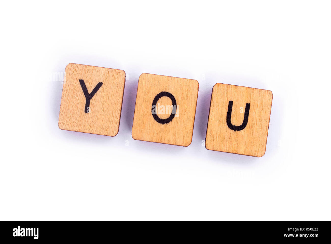 The word YOU, spelt with wooden letter tiles Stock Photo - Alamy