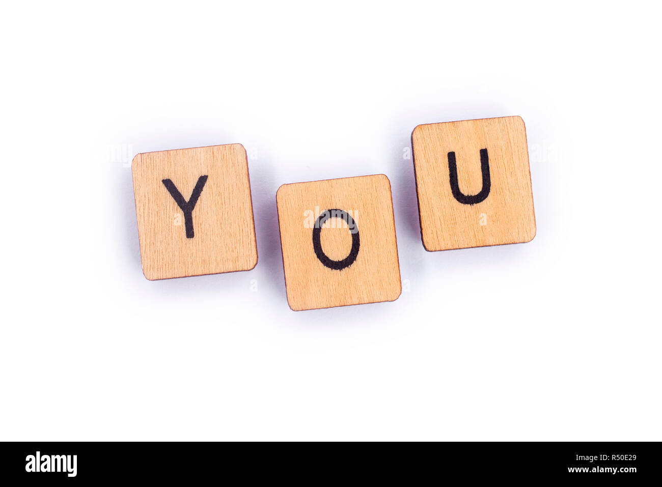 The word YOU, spelt with wooden letter tiles Stock Photo - Alamy