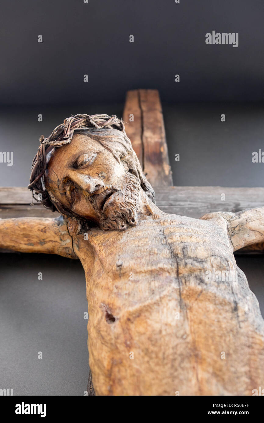 Holy Crucified Jesus Christ close-up. Ancient wooden sculpture. Bottom view. Sacred figure Stock ...