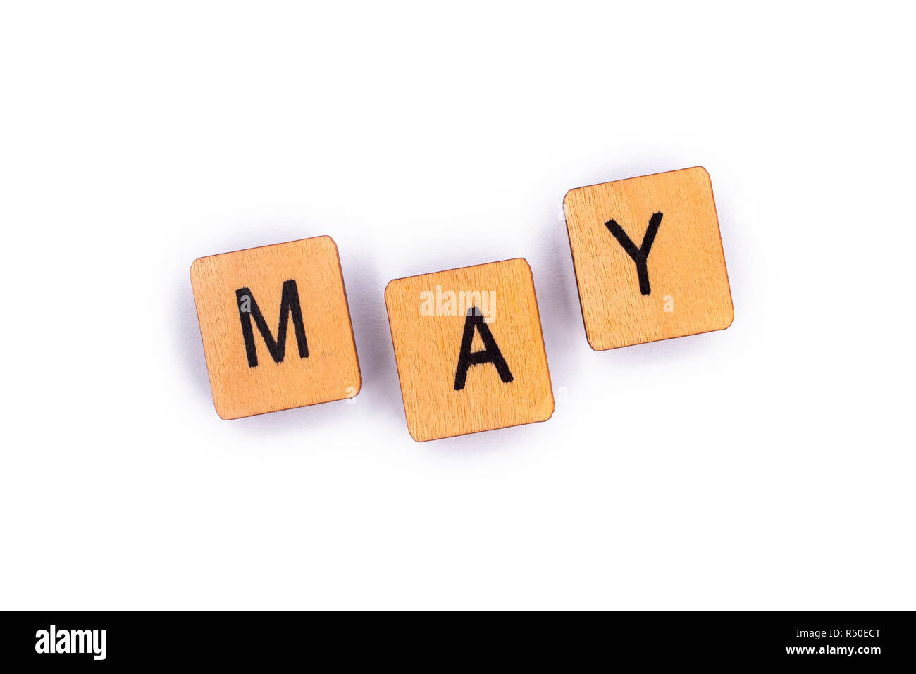 MAY, spelt with wooden letter tiles over a plain white background Stock ...